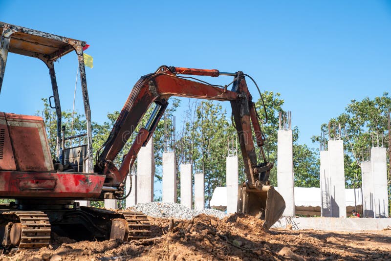 Hydraulic Excavator is Digging Soil at a Construction Site, Surrounded ...