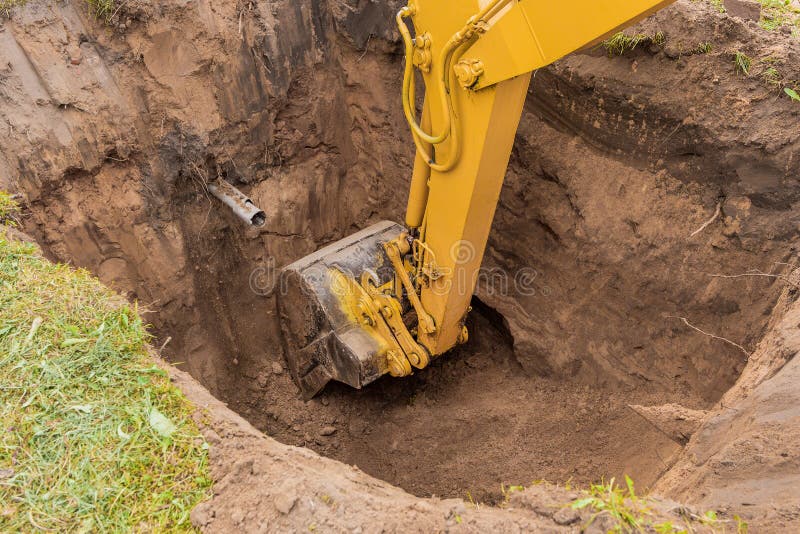 Hydraulic Excavator Piston Digs Deep Pit in Industrial Area on ...