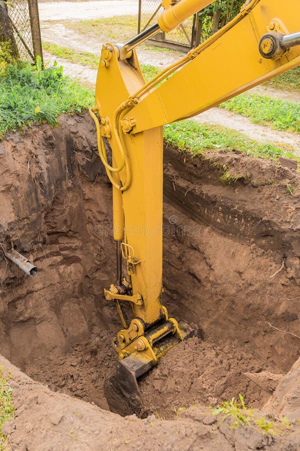 Hydraulic Excavator Piston Digs Deep Pit in Industrial Area on ...