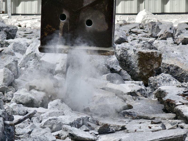 A Hydraulic Hammer Breaking Concrete at a Construction Site Stock Image ...