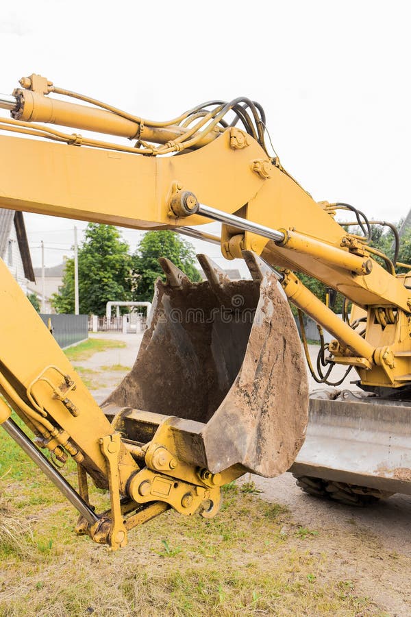 Hydraulic Piston System Excavator with a Bucket and a Pile of Earth ...