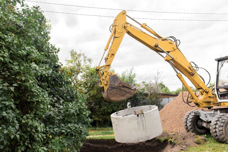 Hydraulic Piston System of the Excavator with a Bucket, Lowering into ...