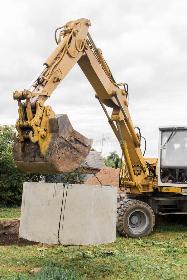 Hydraulic Piston System of the Excavator with a Bucket, Lowering into ...