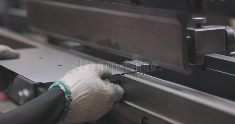 Hydraulic Sheet Metal Bending Machine. a Worker Bends a Metal Part in a ...