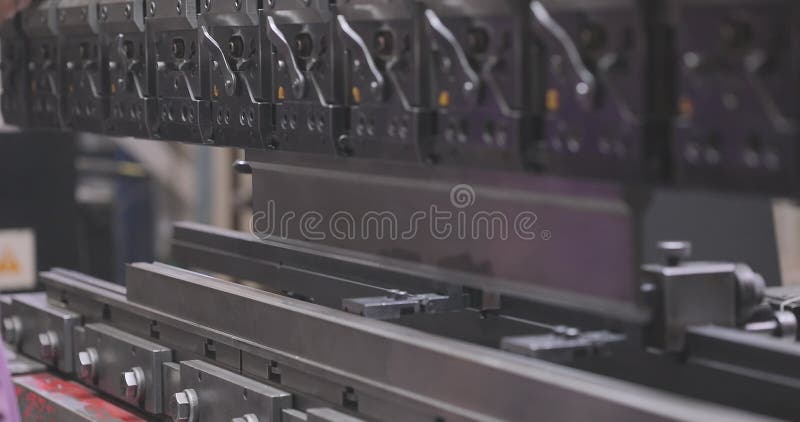 Hydraulic Sheet Metal Bending Machine. a Worker Bends a Metal Part in a ...