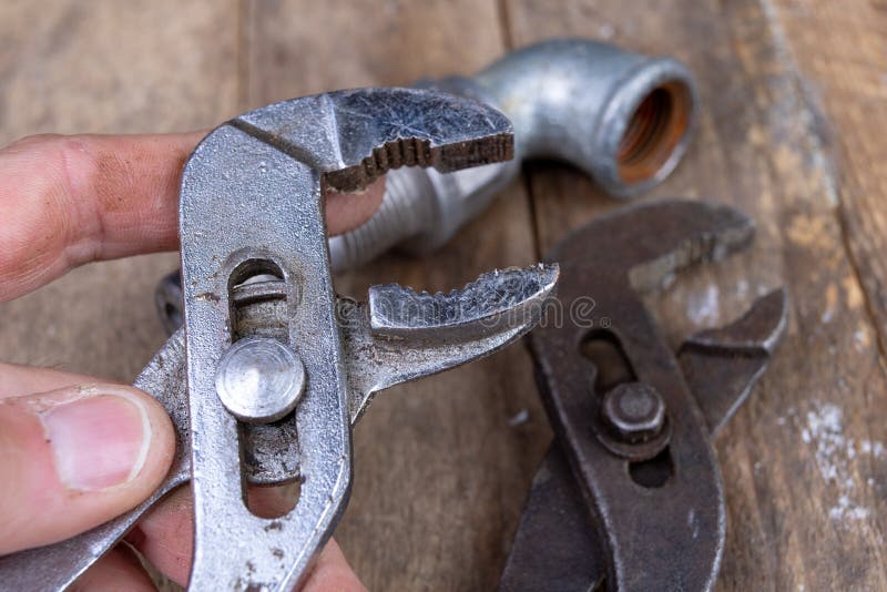Hydraulic Wrench and Steel Pipes on a Workshop Table. Minor Mechanical ...