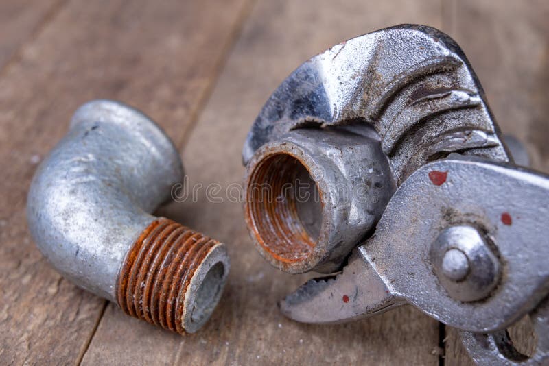 Hydraulic Wrench and Steel Pipes on a Workshop Table. Minor Mechanical ...