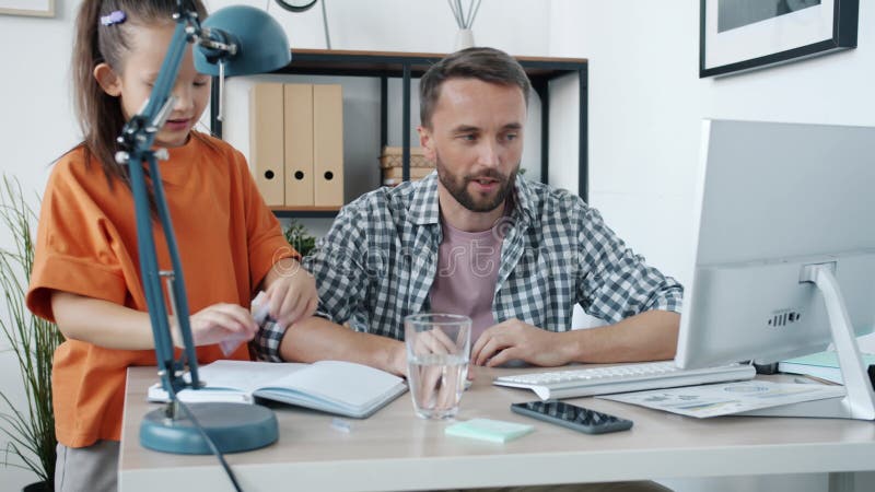 Hyperactive Child Bothering Father Who is Working from Home Using Computer and Talking on Mobile ...
