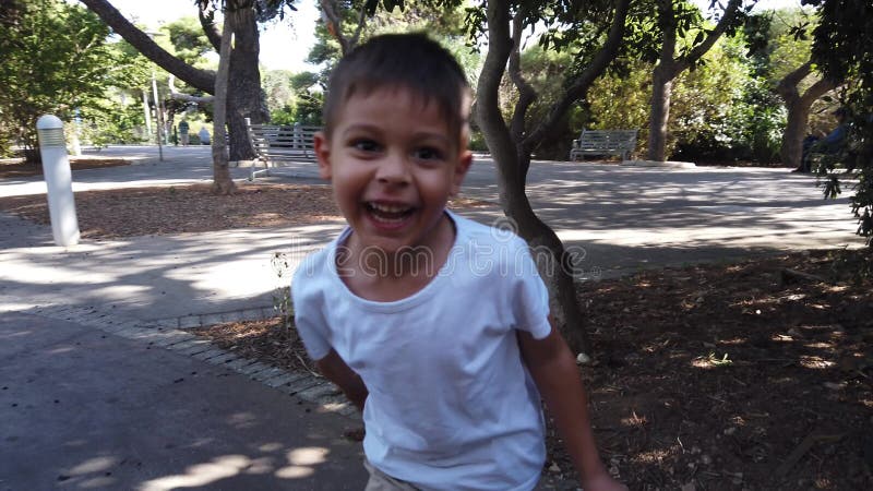 Hyperactive Child, Hiding Behind the Bushes and Running in the Park ...