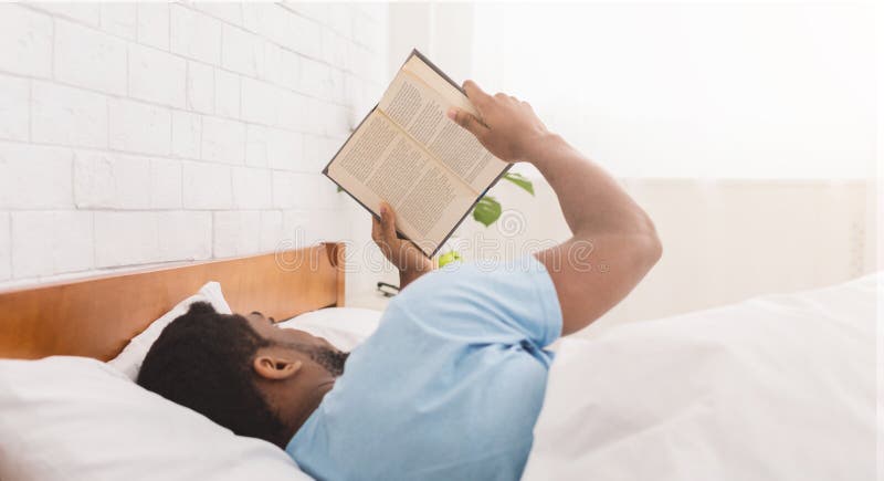 Young Black Man Trying To Read Book in Bed Stock Image - Image of ...