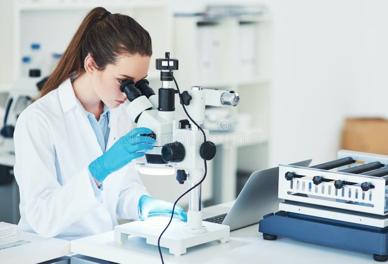 I Can See so Much. a Focused Young Female Scientist Looking through a ...