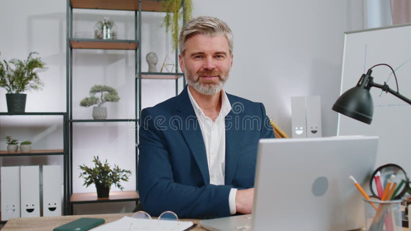 Business Man Working on Office Laptop Pointing To Camera Looking with ...