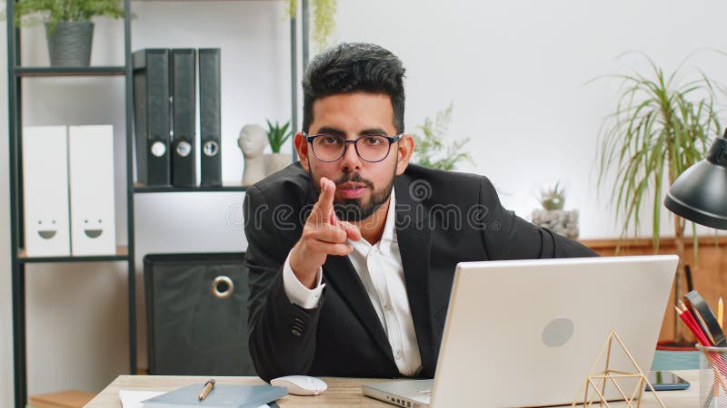 Business Man Working on Office Laptop Pointing To Camera Looking with ...