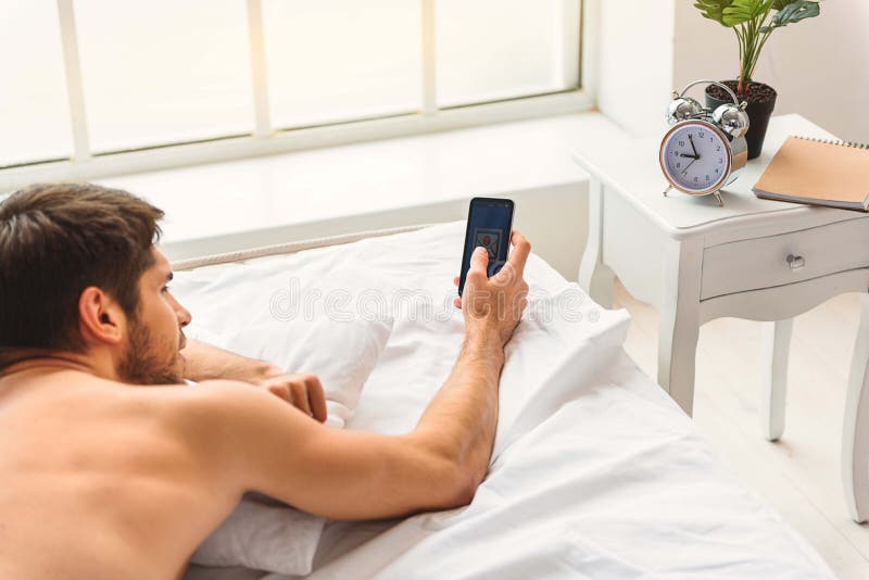 Man Lying Bed Checking Messages Mobile Phone Stock Photos - Free ...