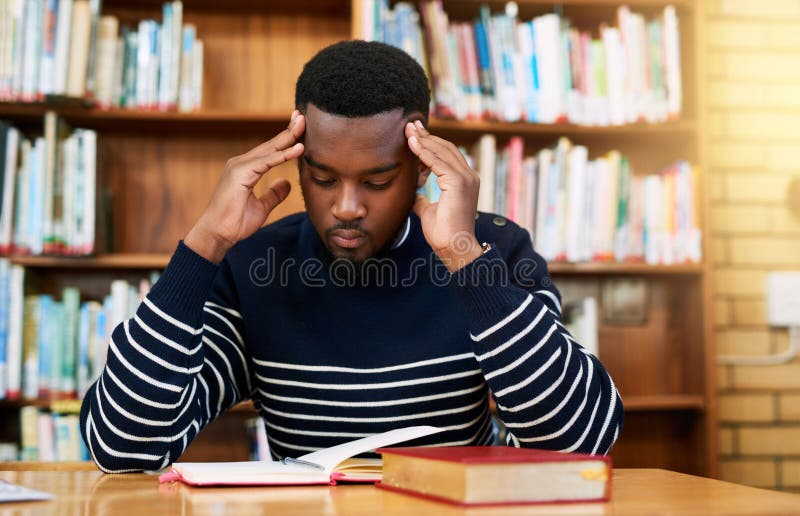 I Have To Start Focusing. a University Student Looking Stressed while Sitting in the Library ...