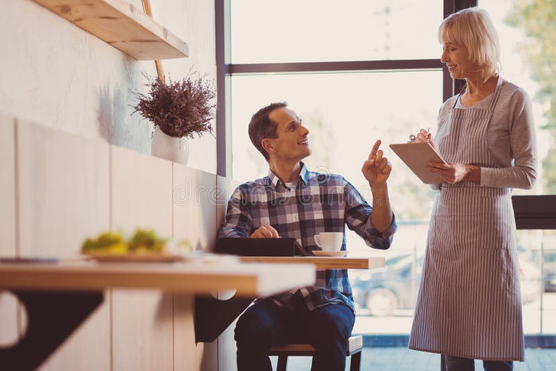 Cheerful Young Man Ordering Food in a Cafe Stock Image - Image of ...