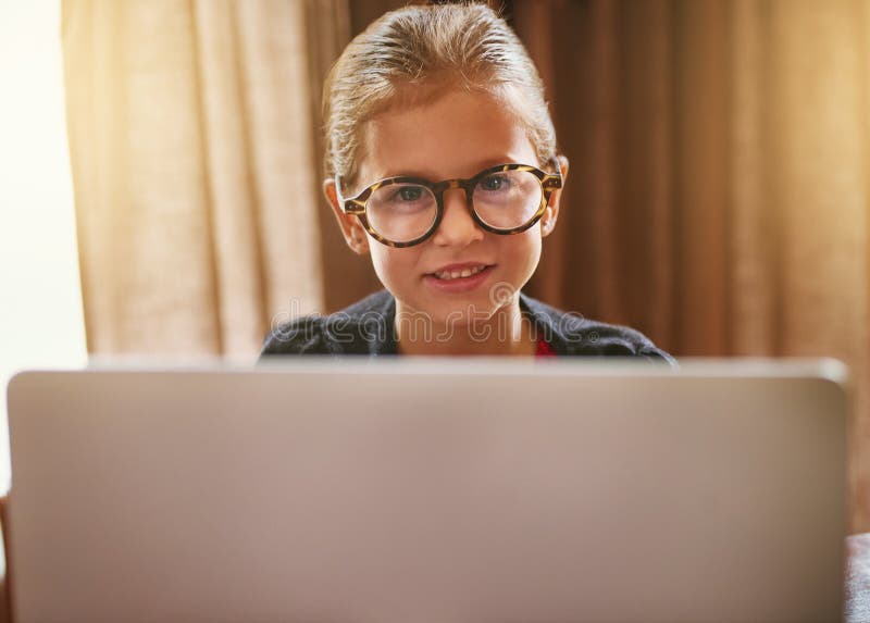 I Learn so Much from My Laptop. a Little Girl Using a Laptop at Home ...