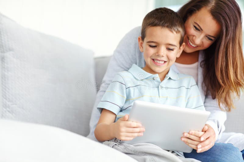I Need Moms Help. a Mother Helping Her Son Use a Digital Tablet. Stock ...