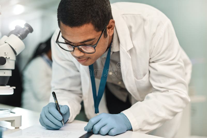 I Should Note that Down. a Young Scientist Writing Notes while Working ...