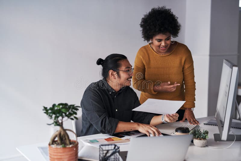 I Think You Should Do this. Two Young Businesspeople Working Together ...