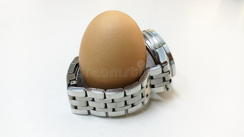 An Egg with a Clock Necklace on the Office Table. Stock Photo - Image ...