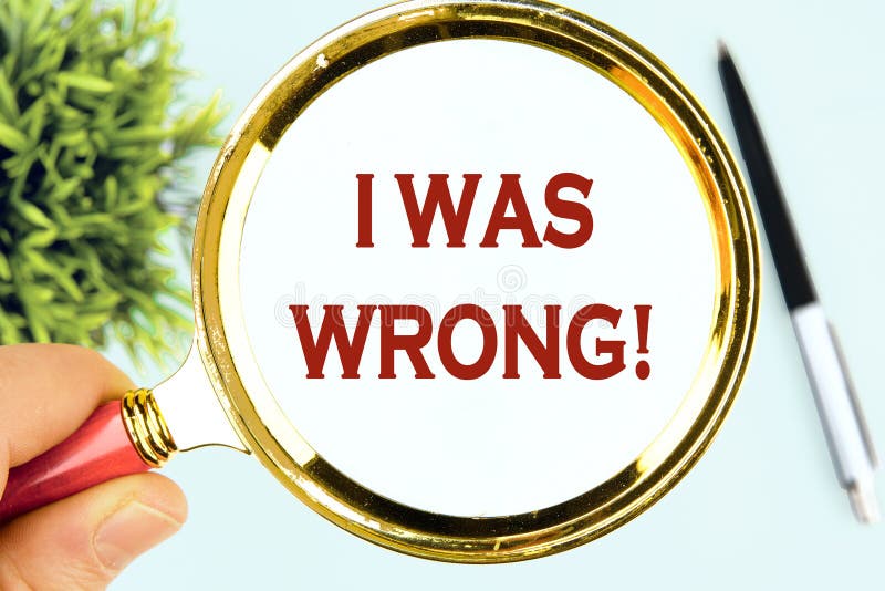 I WAS WRONG Text Written through a Magnifying Glass, Top View on a ...