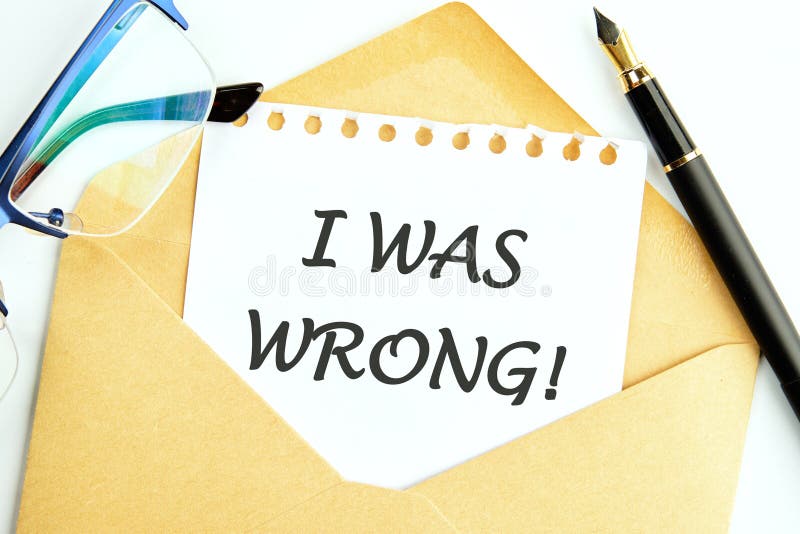 I WAS WRONG Text Written on a White Sheet of Notepad Sticking Out of an ...