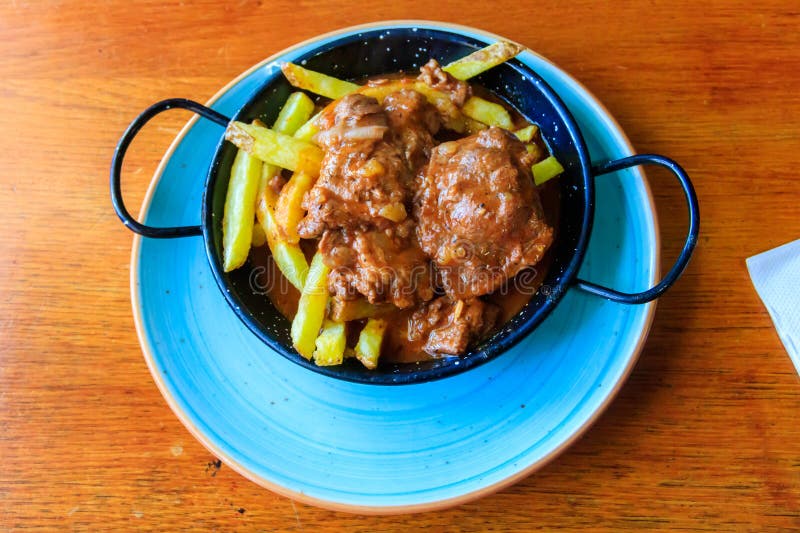 Iberian Pork Cheeks Stew with Potatoes on Wooden Table. Top View Stock ...
