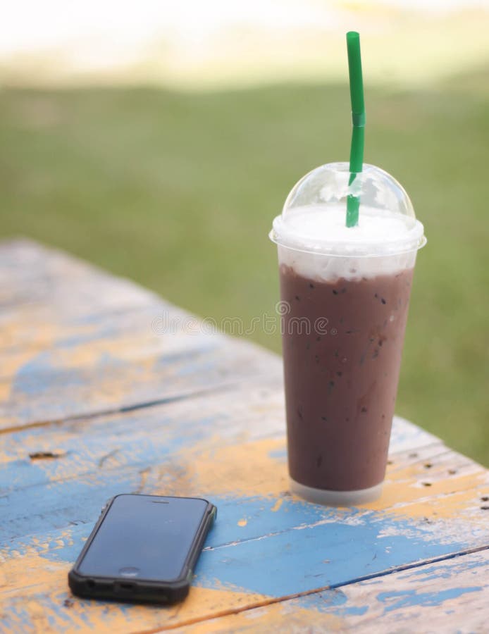 Ice chocolate and phone stock photo. Image of mocha, espresso - 76589074