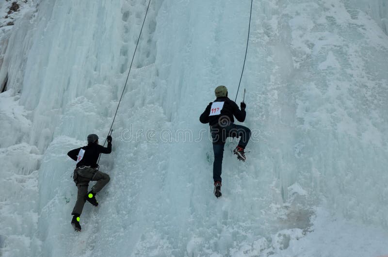 Ice Climbing Competition. Climbers Climb an Ice Cliff Editorial ...