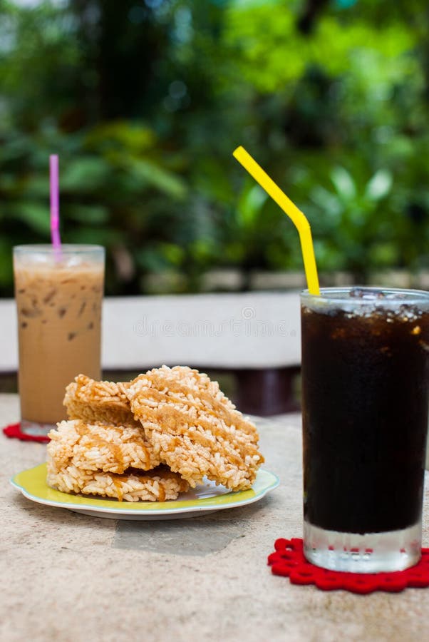 Ice Coffee Americano with Rice Cracker (Khao Tan) Stock Photo - Image ...