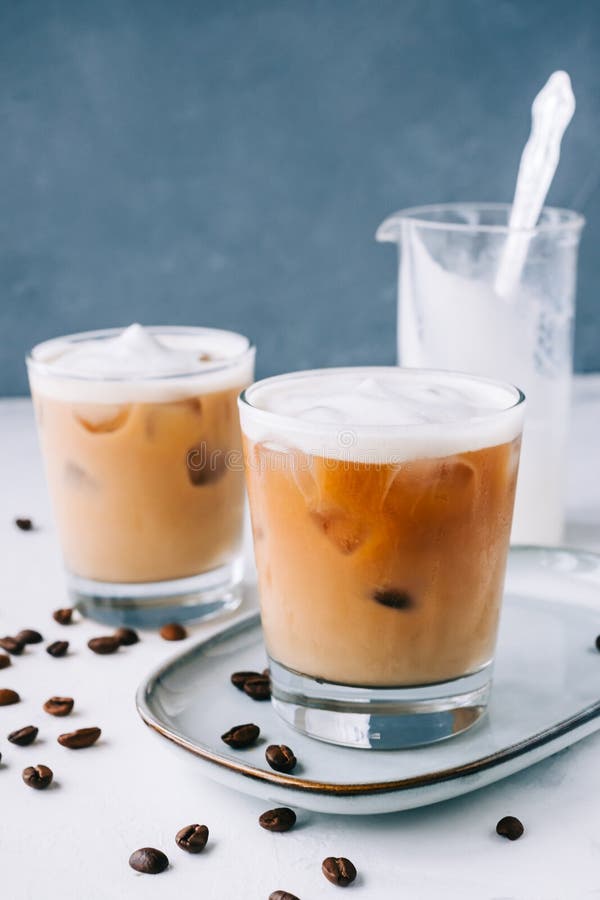 Ice Coffee in Glass with Milk Foam and Ice Cubes, Coffee Beans on White ...
