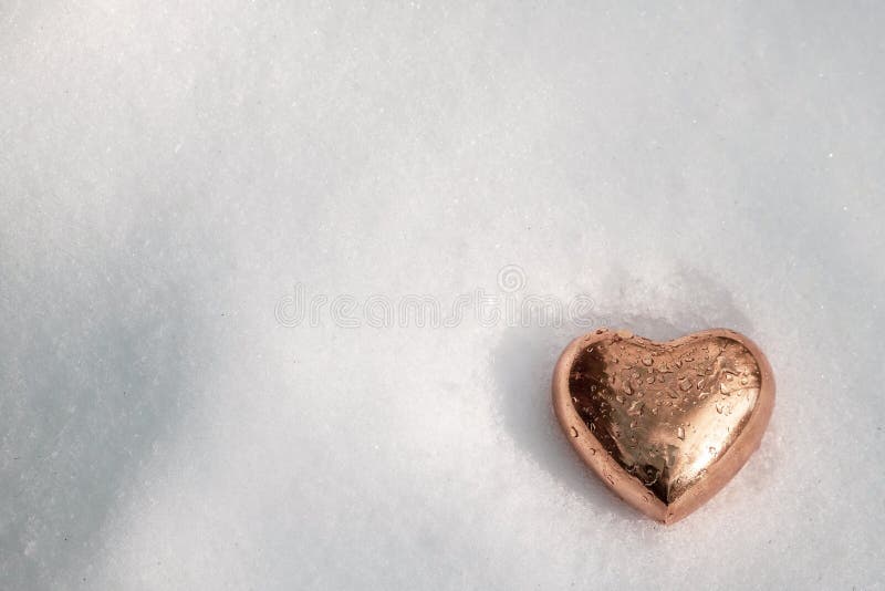 An Ice Cold Heart of Gold Lying in the Snow. Stock Image - Image of ...