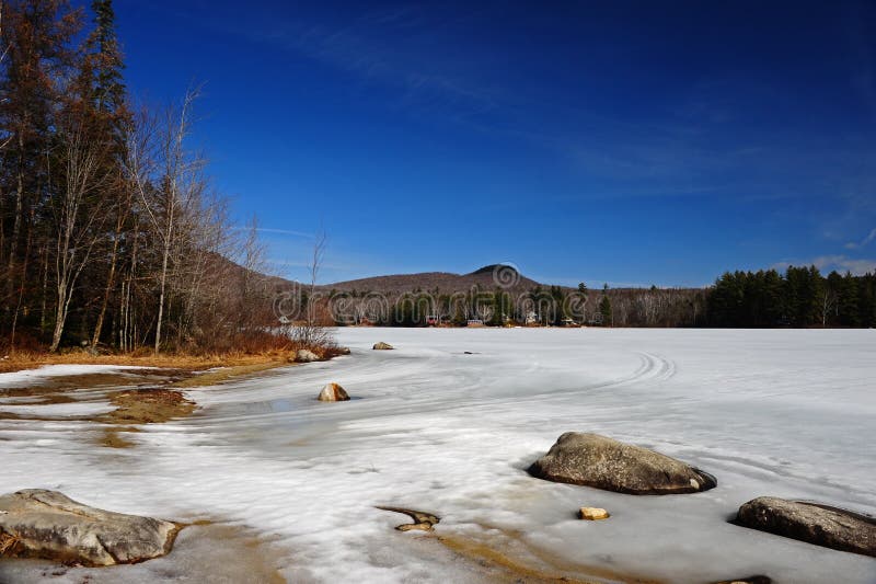Ice covered lake stock photo. Image of spring, cabins - 24287552