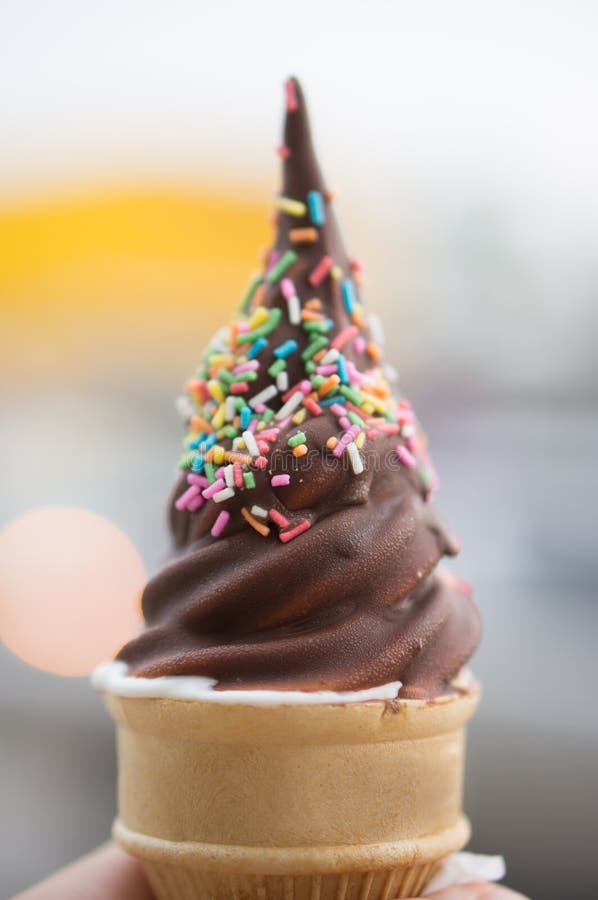 Ice Cream Cone With Chocolate And Rainbow Color Sprinkles On Blu Stock