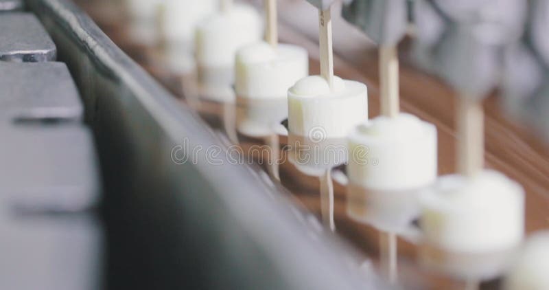 Ice Cream is Dipped into Melted Chocolate Close-up. Chocolate Dripping ...