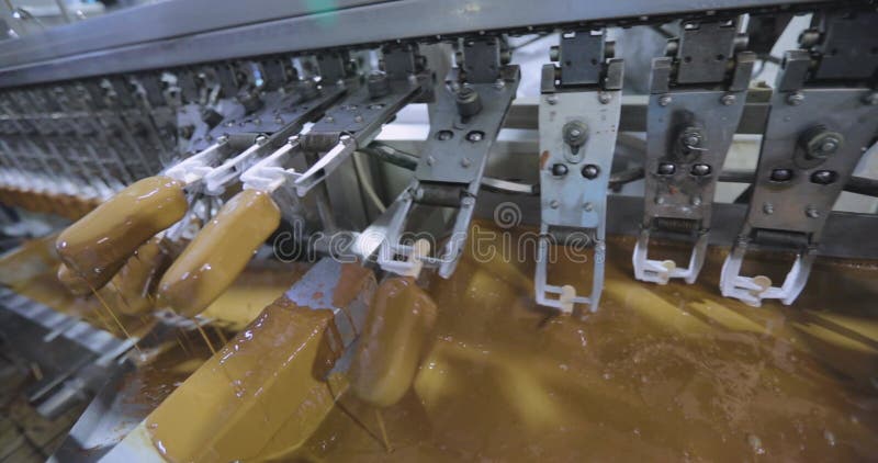 Ice Cream is Dipped into Melted Chocolate Close-up. Chocolate Dripping ...