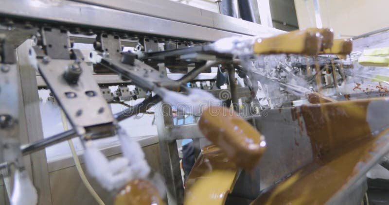 Ice Cream is Dipped into Melted Chocolate Close-up. Chocolate Dripping ...