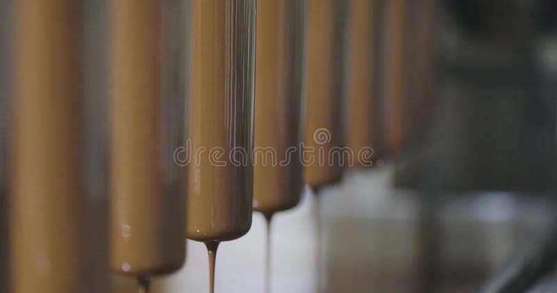 Ice Cream is Dipped into Melted Chocolate Close-up. Chocolate Dripping ...