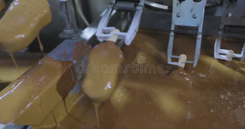 Ice Cream is Dipped into Melted Chocolate Close-up. Chocolate Dripping ...