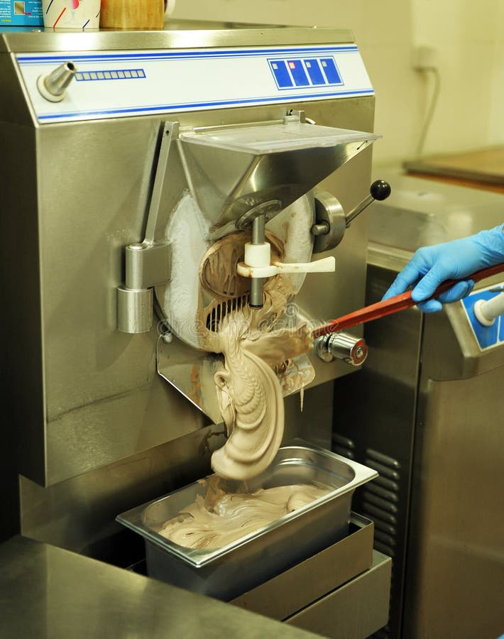 Ice Cream Maker Making Chocolate Ice Cream in the Ice Cream Parlor ...