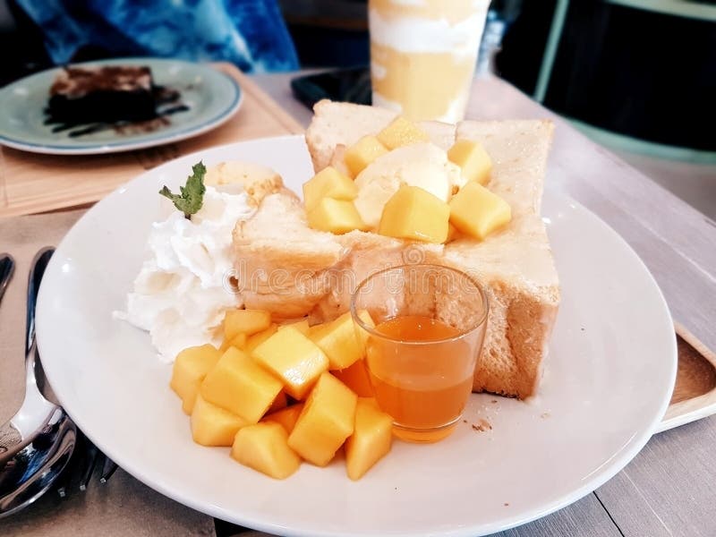 Ice Cream and Mango on Bread. Stock Photo - Image of fresh, golden ...