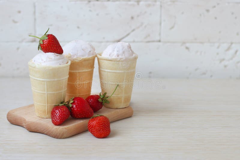 Ice Cream In Waffle Cup Whith Fresh Strawberry On Top Of Ice Cream In