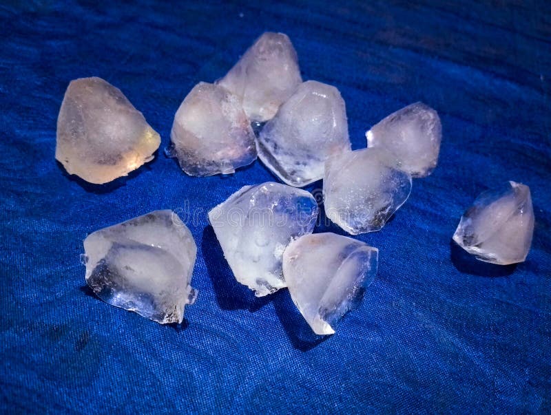 Ice Cube on a Blue Fabric Background. Stock Photo - Image of ...