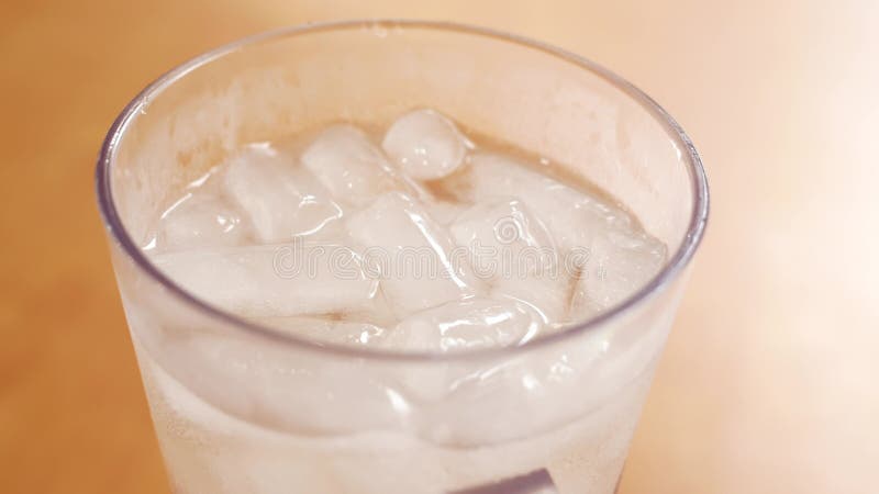 Ice in a Cold Soft Drinks in a Glass on Table Stock Footage - Video of ...