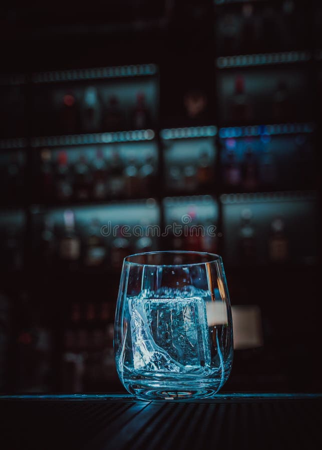 Ice Cube in an Empty Glass on a Bar Counterin Bar Stock Image - Image ...