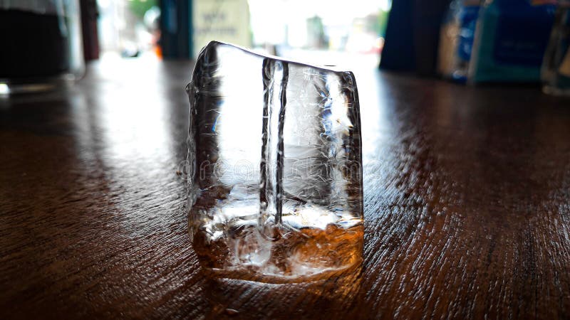 An Ice Cube Stand Alone and Melting Stock Photo - Image of melting ...