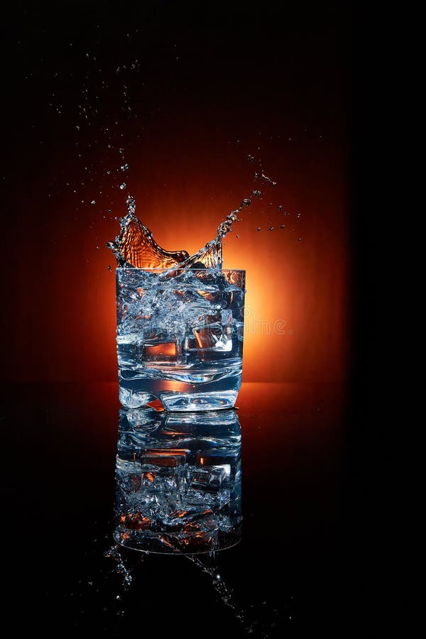 Ice Cube and Water Splash in a Clear Glass. Stock Image - Image of cube ...