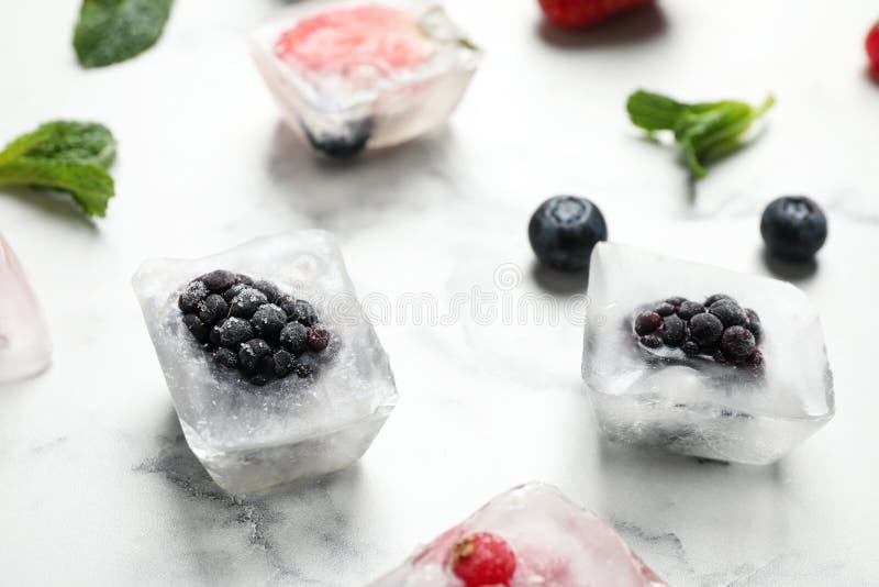 Ice Cubes with Blackberries on White Marble Table, Closeup Stock Image ...