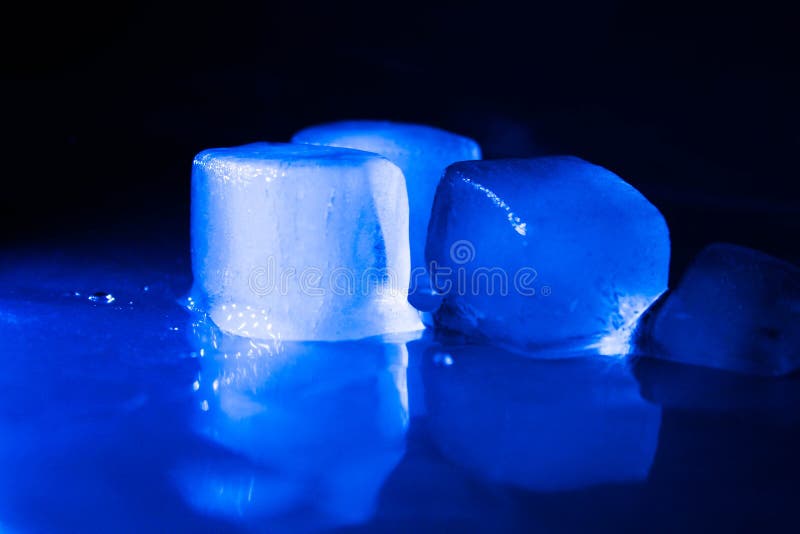 Ice cubes in blue light stock photo. Image of bubble - 167426044